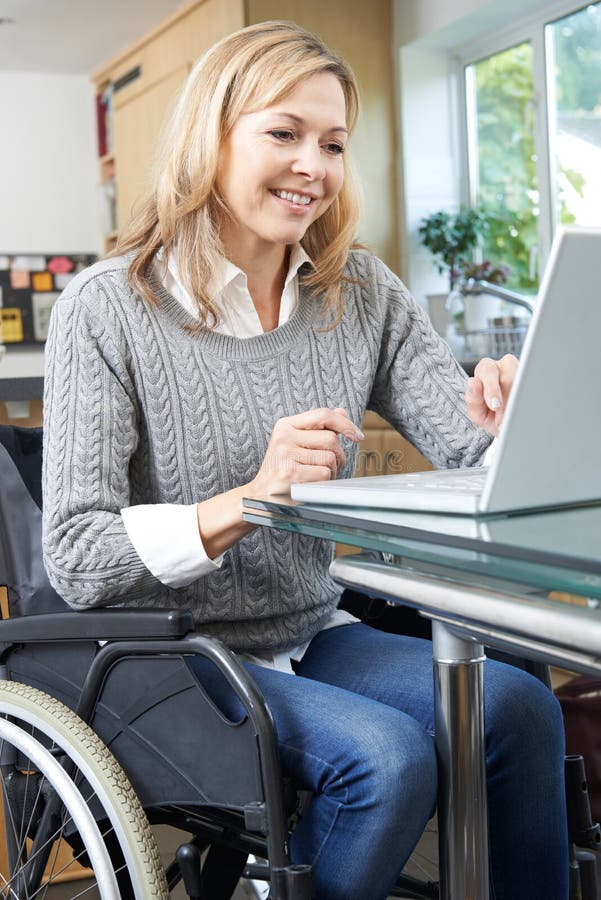 Disabled Woman in Wheelchair Using Laptop at Home Stock Photo - Image ...