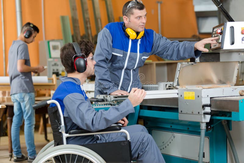 Disabled Worker in Wheelchair in Factory and Colleague Stock Photo ...