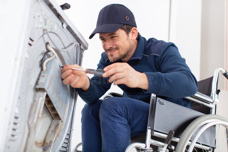 Disabled Working Man Plumber Repairs Washing Machine in Laundry Stock ...