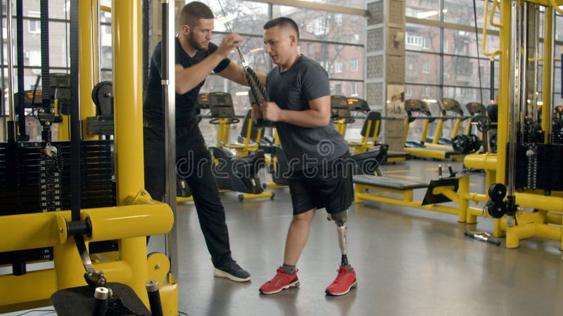 Disabled Young Man with Instructor Working Out in Gym Stock Image ...