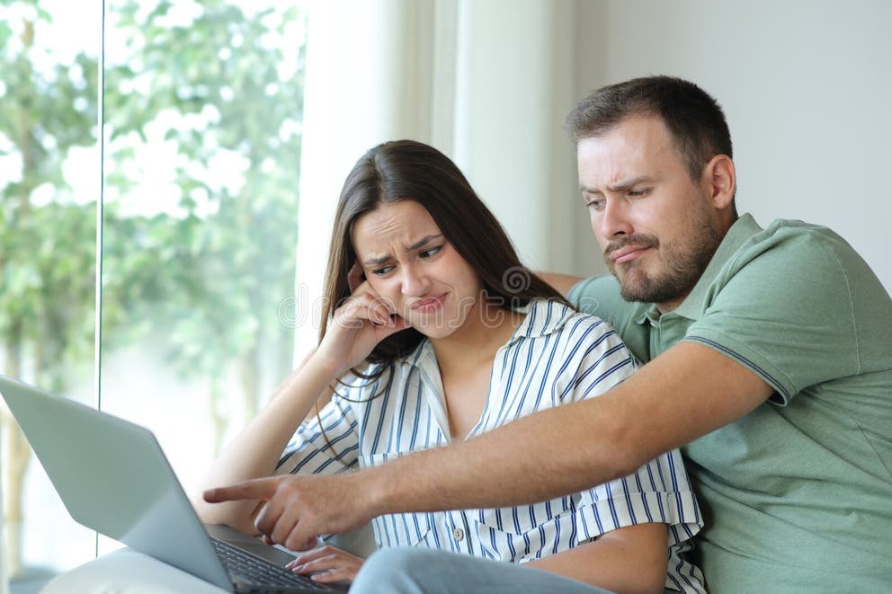 Disappointed Couple Checking Personal Computer at Home Stock Photo ...