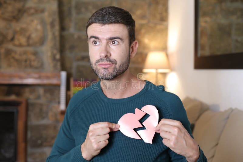 Disappointed Man Holding a Broken Heart Stock Photo - Image of hand ...