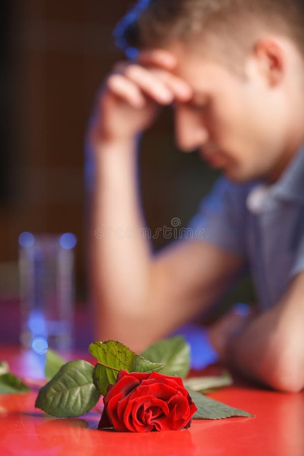 Disappointed Man Sitting with Red Rose on Table. Stock Photo - Image of ...