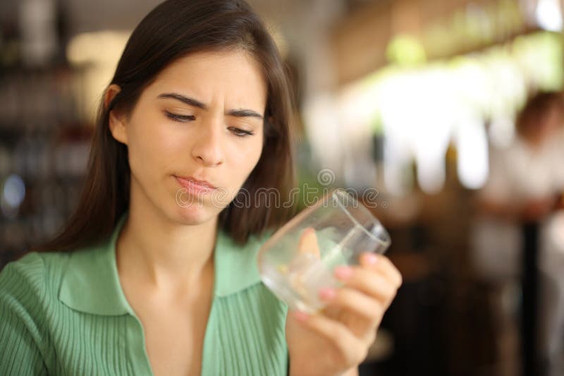 Disappointed Woman Looking at Empty Glass in a Bar Stock Image - Image ...