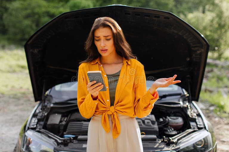 Disappointed Woman Using Cellphone while Standing in Front of Broken ...