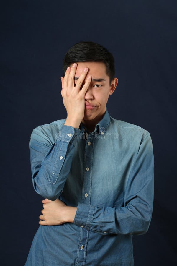 Disappointed Young Asian Man Covering His Face by Palms Stock Photo ...