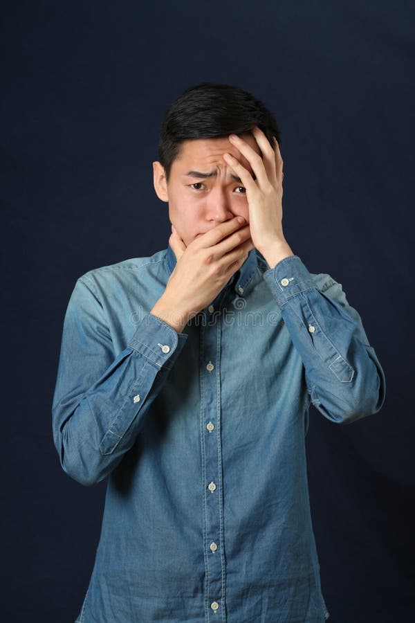Disappointed Young Asian Man Covering His Face by Palms Stock Photo ...