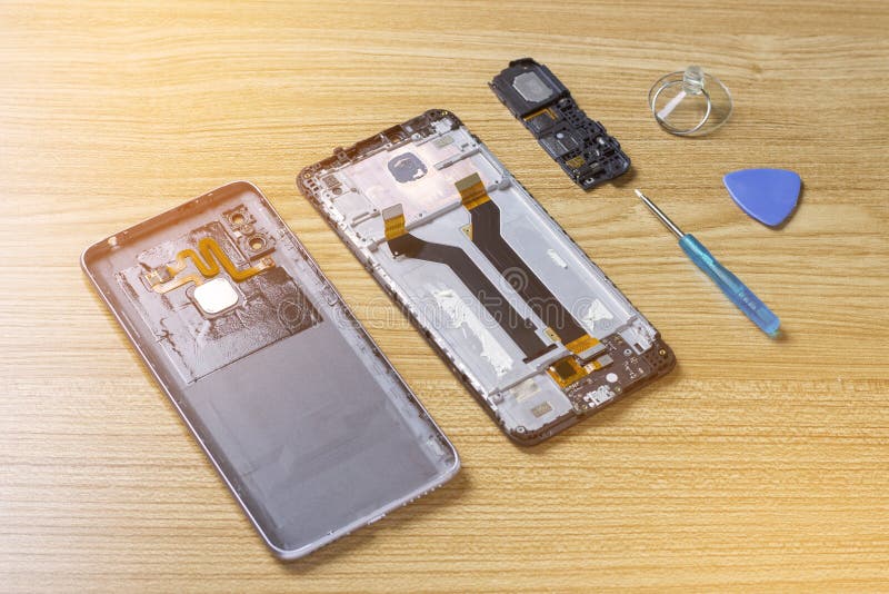 Disassembled Broken Smartphone on a Wooden Table, Top View Stock Photo ...