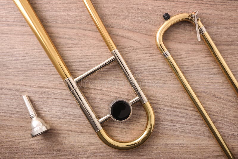Disassembled Golden Trombone on Wooden Table Top View Stock Photo ...