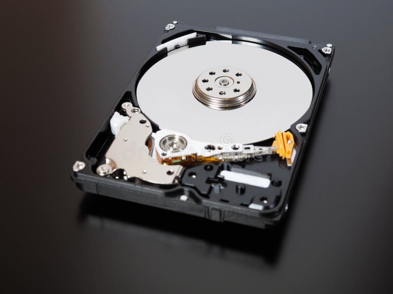 A Disassembled Open Hard Disk Drive HDD of a Computer or Laptop Lies on ...