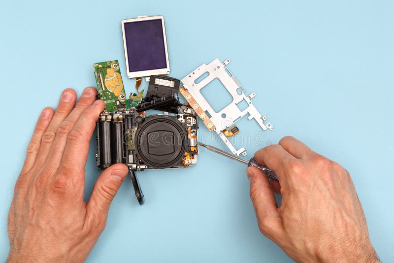 Disassembling a Photo Camera Stock Photo - Image of hand, motherboard ...