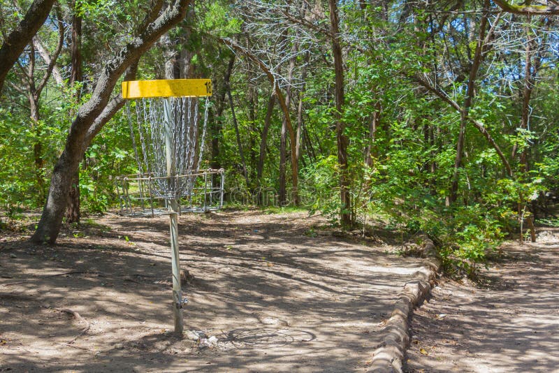 Disc golf basket and trees stock image. Image of leisure - 77089907