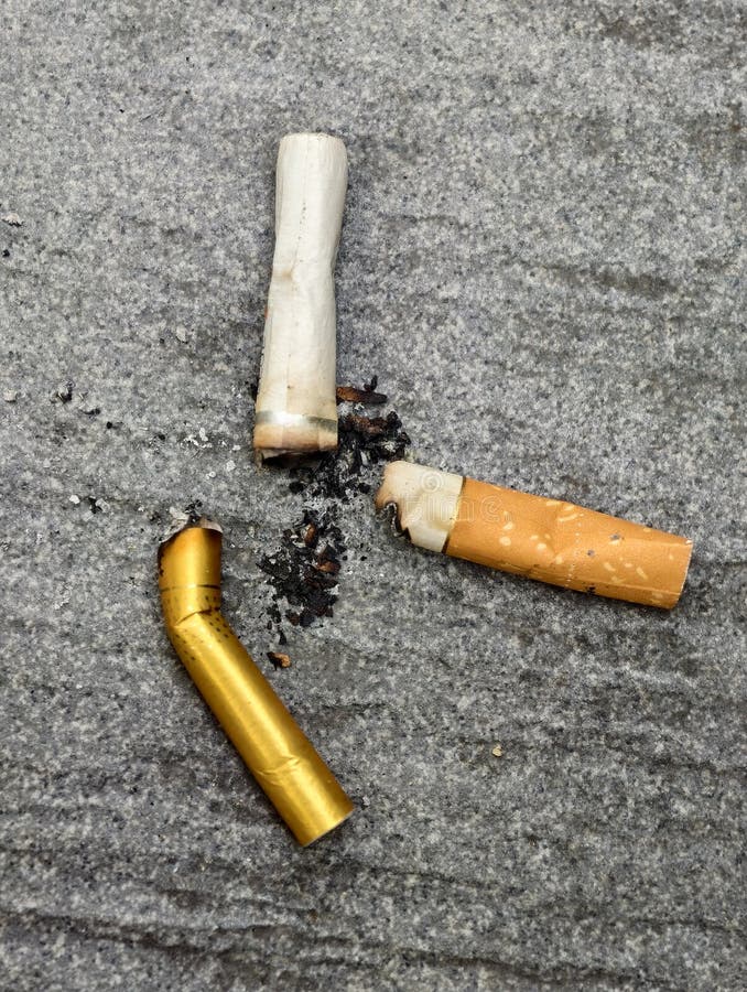 Discarded Cigarette Butts on Ground Representing Pollution and Smoking ...