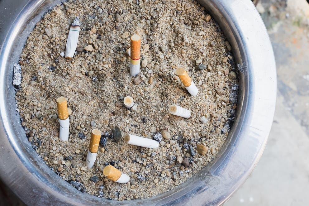 Discarded Cigarette with Sand Stock Photo - Image of cigarette, dirty ...