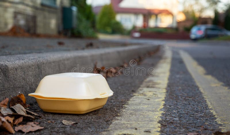 Discarded Food Container in Gutter by the Side of the Road Stock Photo ...
