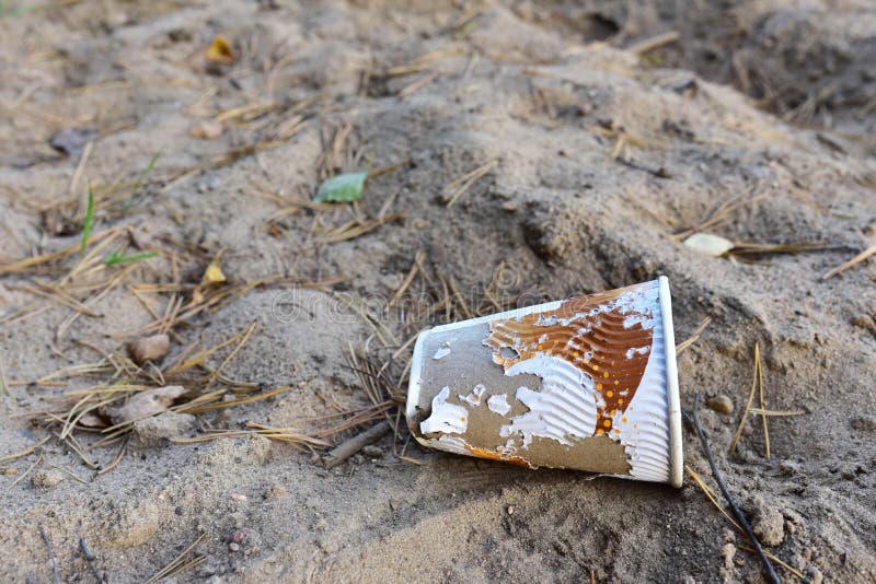 Discarded Paper Coffee Cup on Ground. Disposable Coffee Cup on Sand ...