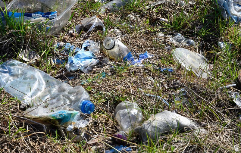 Discarded Plastic Bottles and Containers on Grassy Land. Stock Image ...