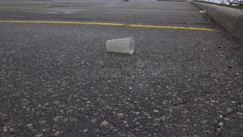 A Discarded Plastic Cup Lying in a Empty Parking Lot Blows Down Wind ...
