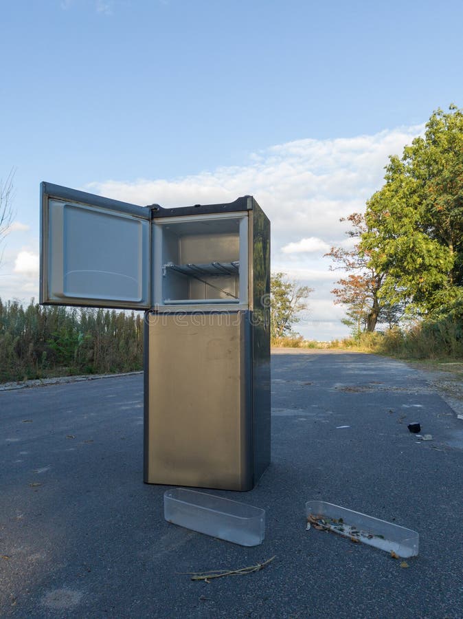 Discarded Refrigerator with Open Door Left on Roadside Stock Image ...