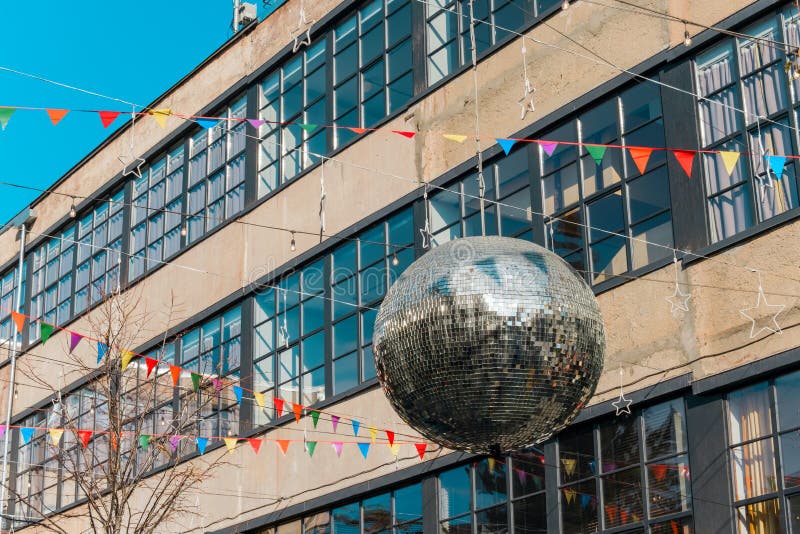 Disco Ball and Colorful Flags in the Courtyard of a Multi Storey ...