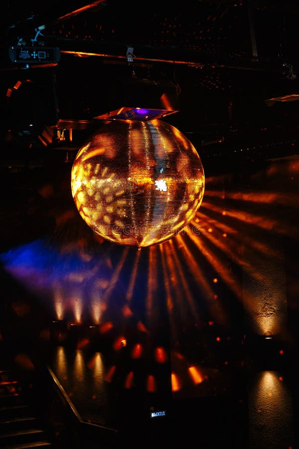 Disco Ball Hanging on the Ceiling of the Disco Rays of Light are ...
