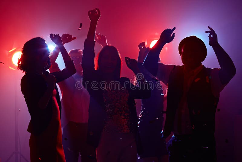 Disco dancing in red light stock photo. Image of motion - 73405114