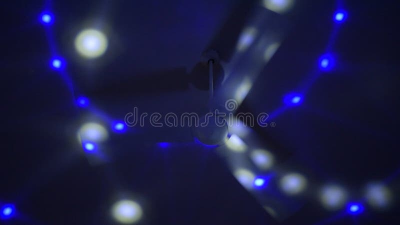 Disco Lights Reflecting Off a Rotating Ceiling Fan at Night Stock ...