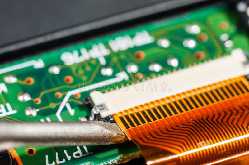 Disconnecting the Chip from the Flat Cable with a Screwdriver, Close-up ...