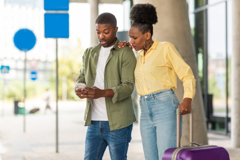 Discontented African American Tourists Couple Using Smartphone Having ... Discontented African American Tourists Couple Using Smartphone Having ...