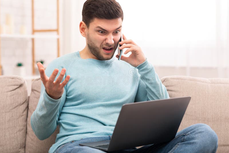 Discontented Man Complaining by Phone Sitting on Couch at Home Stock ...