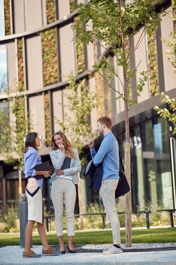 Discuss in Front of Business Centre.Business Friends Talks Together ...