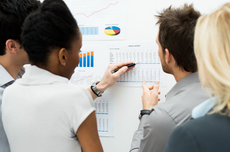 Discussing annual report stock image. Image of businessman - 30551741