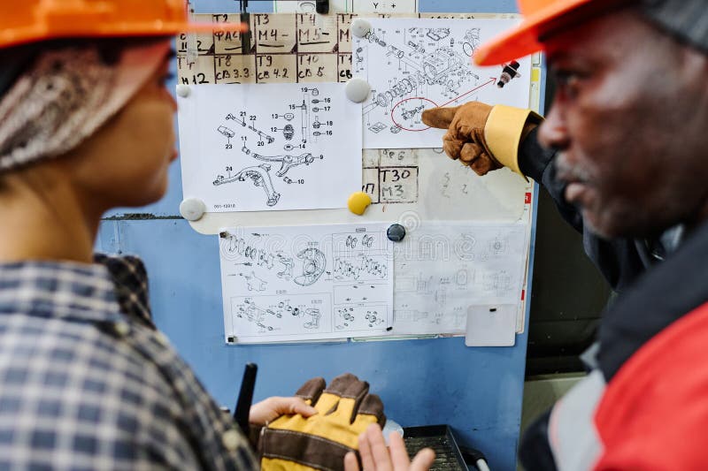Discussing Engineering Schematics with Team Stock Photo - Image of ...