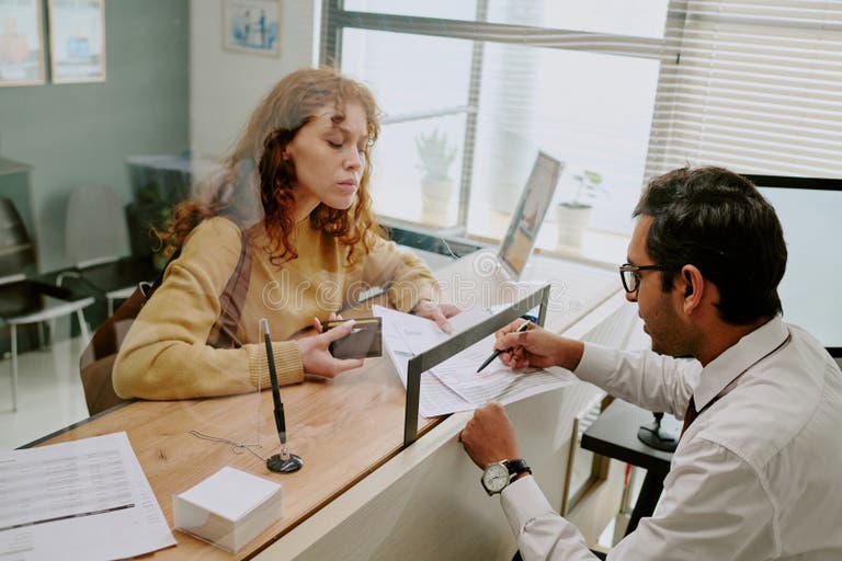 Discussing Important Paperwork in Office Setting with Client Stock ...