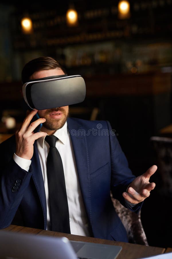 Discussing Presentation on Phone Using VR Goggles Stock Photo - Image ...