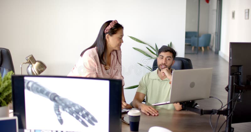 Discussing Robotic Arm Design, Colleagues Collaborating Using Laptop in ...