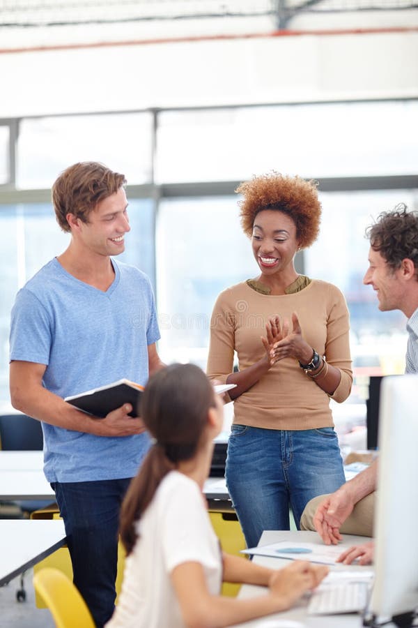 Discussing Their Latest Project. a Group of Colleagues Talking in the ...