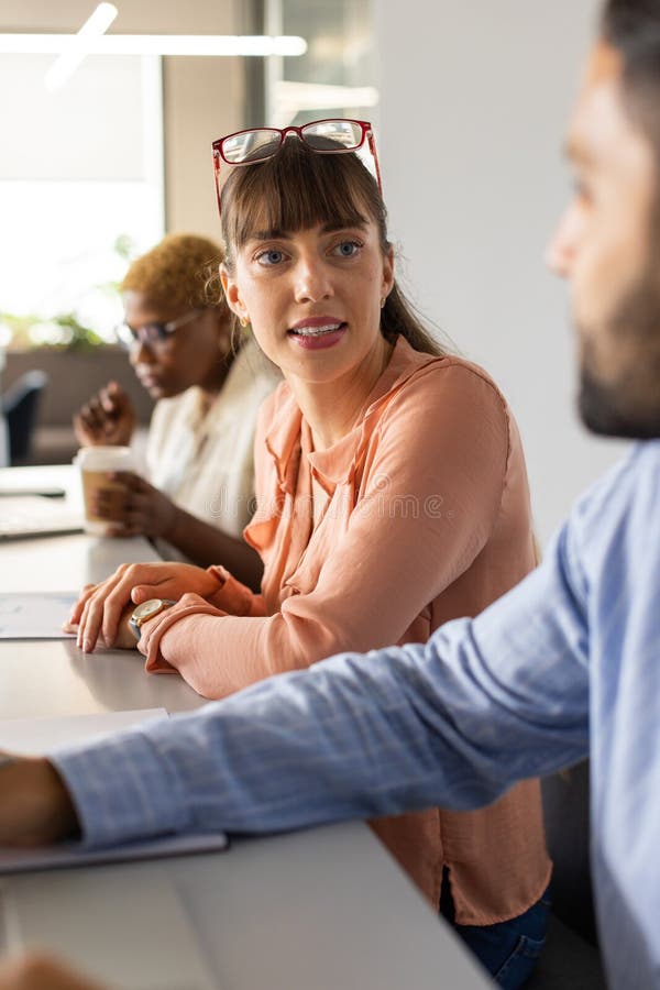 Discussing Work, Colleagues Collaborating at Desk with Laptops in ...