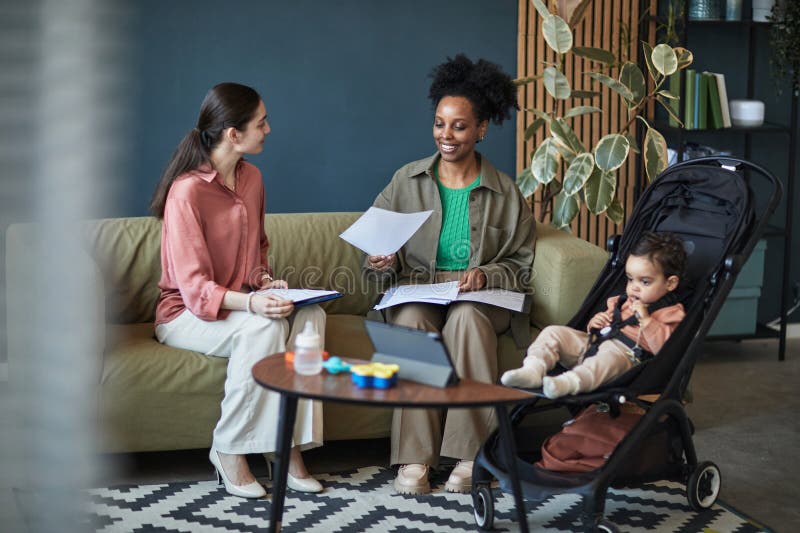 Discussing Work Documents in Casual Office Setting Stock Image - Image ...