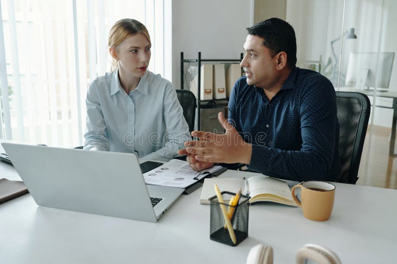 Discussing Work Projects in Modern Office Setting Stock Image - Image ...