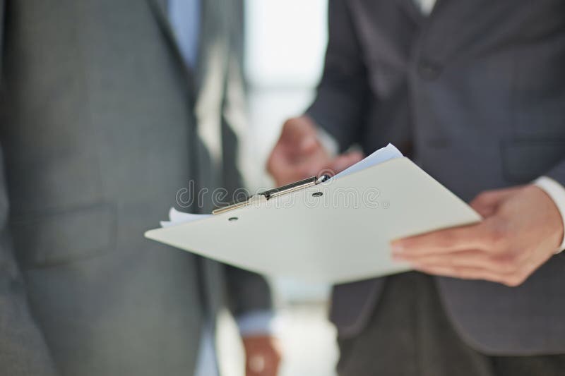 Discussion between Two Businessmen Looking at Documents Stock Image ...
