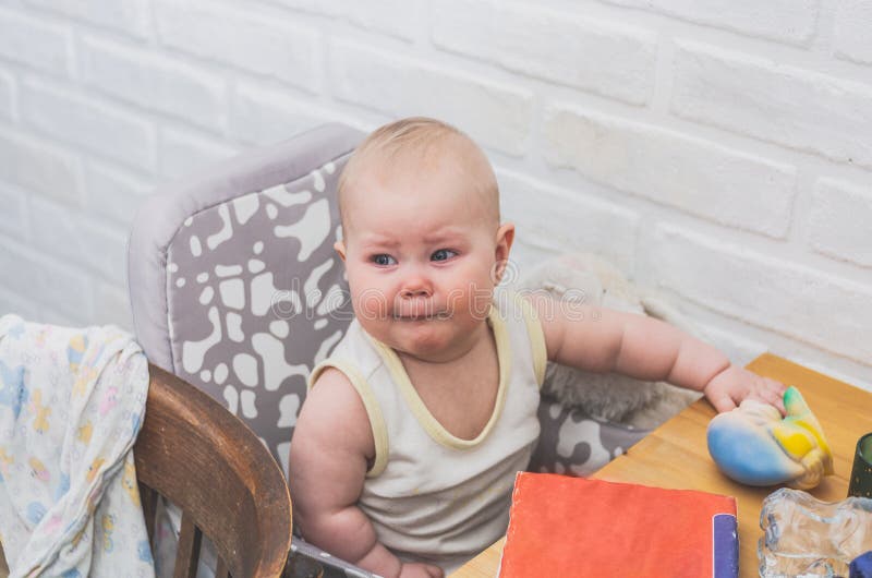 Disgruntled Upset Baby Girl Sitting at the Dinner Table Stock Image ...