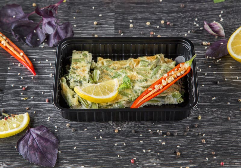 A Dish in a Black Disposable Container from Catering on a Concrete ...