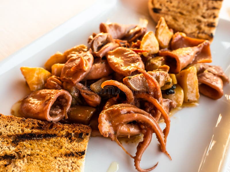 Dish of Cuttlefish and Octopus with Toasted Bread Stock Photo - Image ...