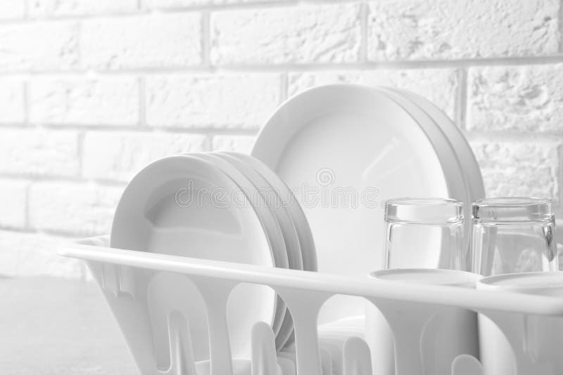 Dish Drainer with Clean Plates on Table Stock Photo - Image of glasses ...