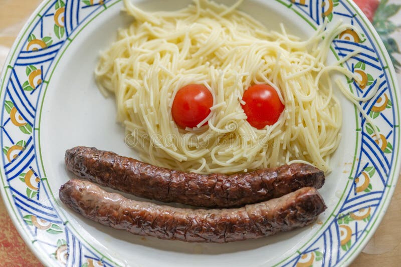 Dish Face with Sausages, Tomatoes and Pasta Stock Photo - Image of ...