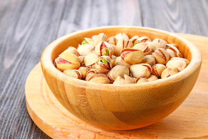 Dish Full of Pistachios with More Pistachios on Side. Stock Photo ...