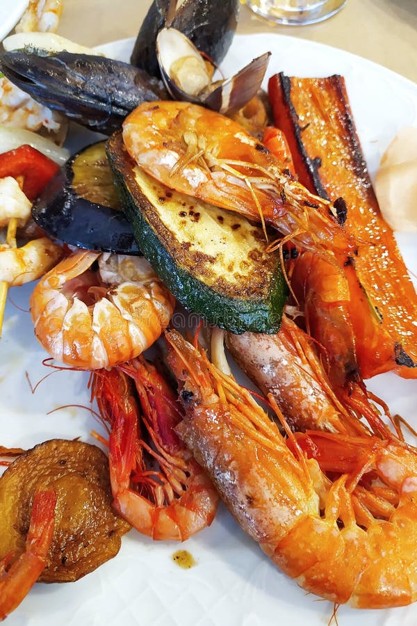 A Dish with Seafood and Grilled Vegetables in Close-up. Mixed Seafood ...