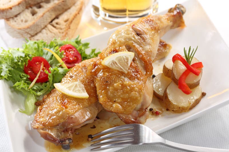 Dish of Two Roasted Chicken Legs Stock Image - Image of food, lemonl ...