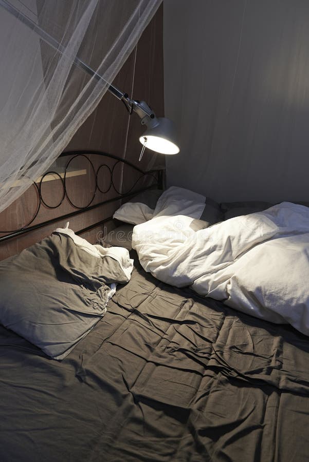Disheveled Sheets and Pillows of an Unmade Bed Stock Photo - Image of ...